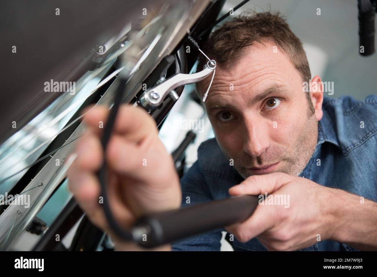 concentrated man pumping wheel bike Stock Photo - Alamy