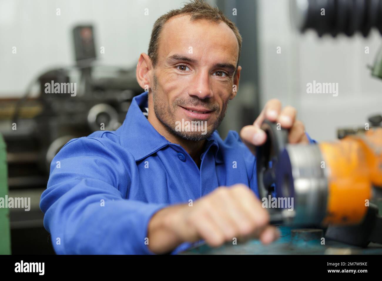 a machinist adjusting a machine Stock Photo - Alamy