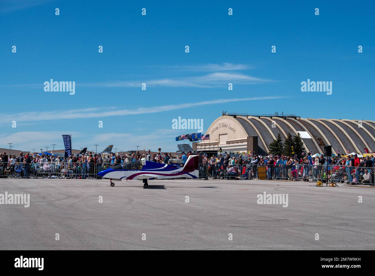 Patrons watch an aerial act perform during the Ellsworth Air & Space ...