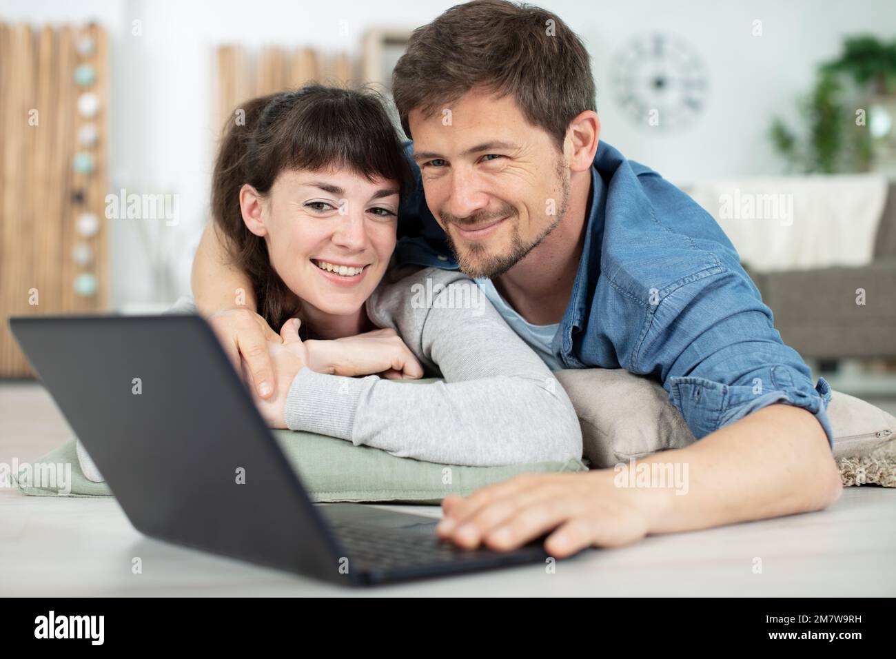 beautiful couple checking a pc Stock Photo - Alamy