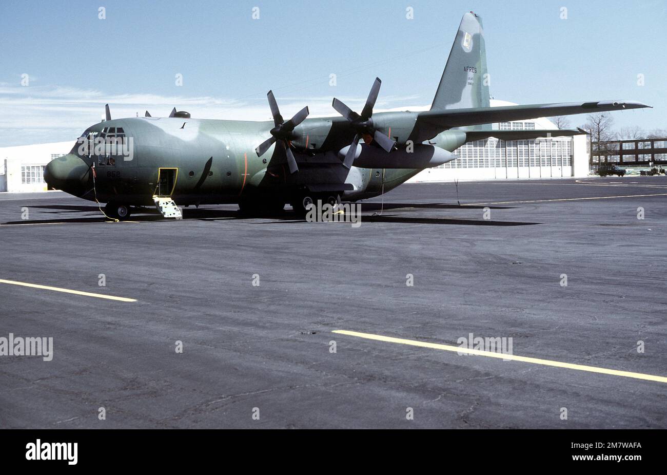 Left front view of two C-130 Hercules aircraft with a European paint scheme, on the 459th Flight ...