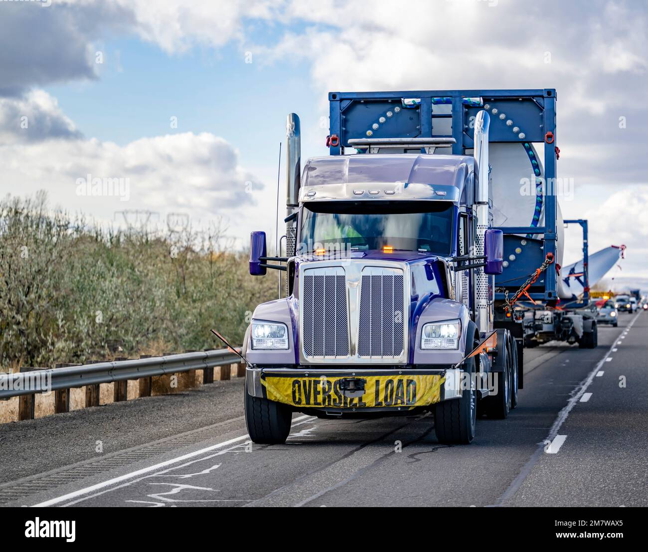 Industrial blue big rig semi truck tractor with additional trolley ...