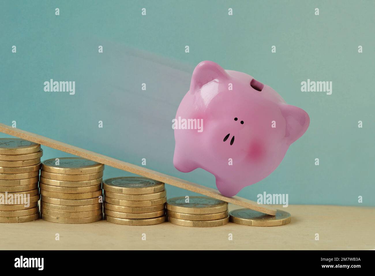 Piggy bank on decreasing piles of coins - Concept of finance and losing ...