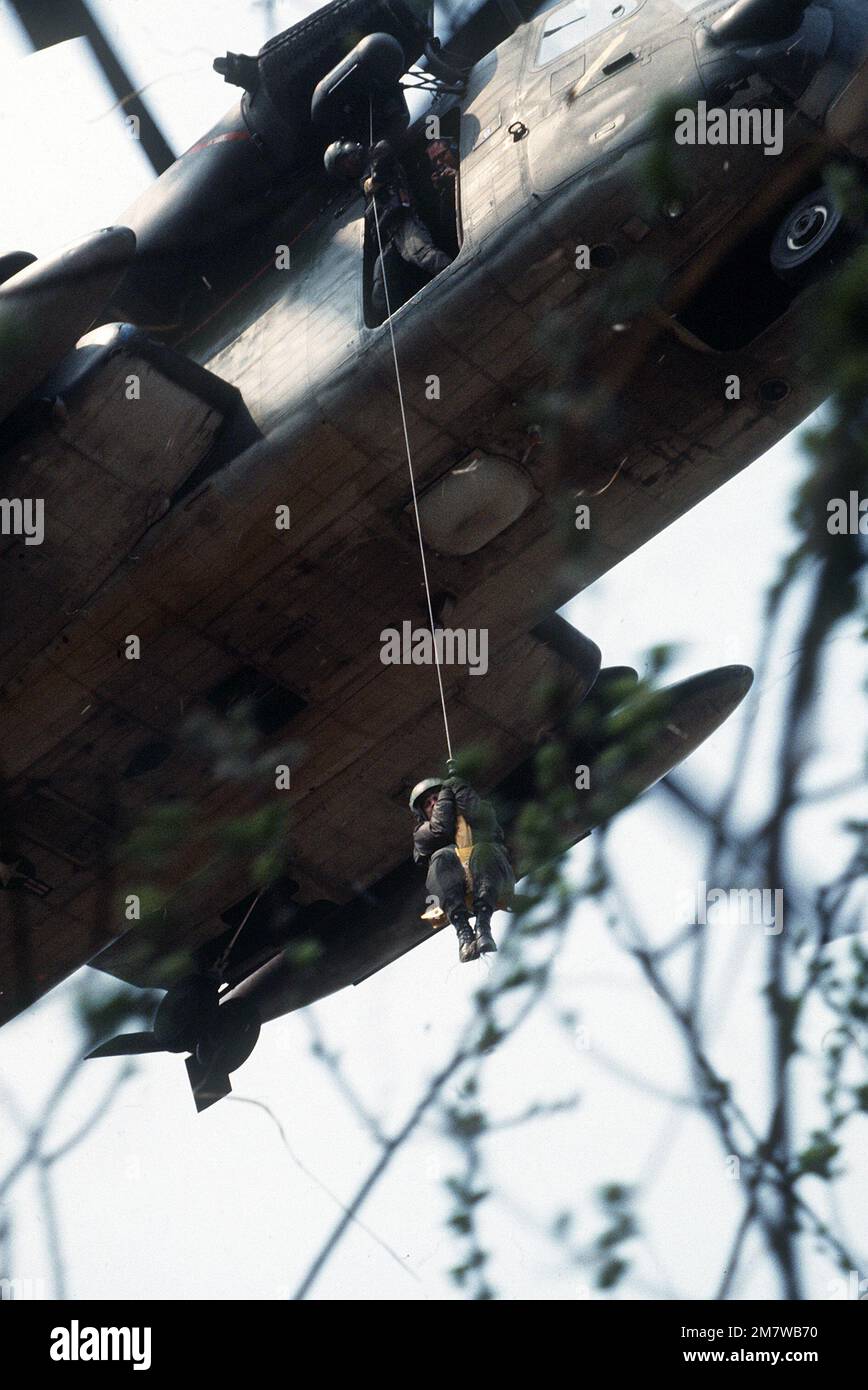 Ground-to-air view of a search and rescue CH-52 Super Jolly helicopter, as downed pilot, MAJ. Ed ...