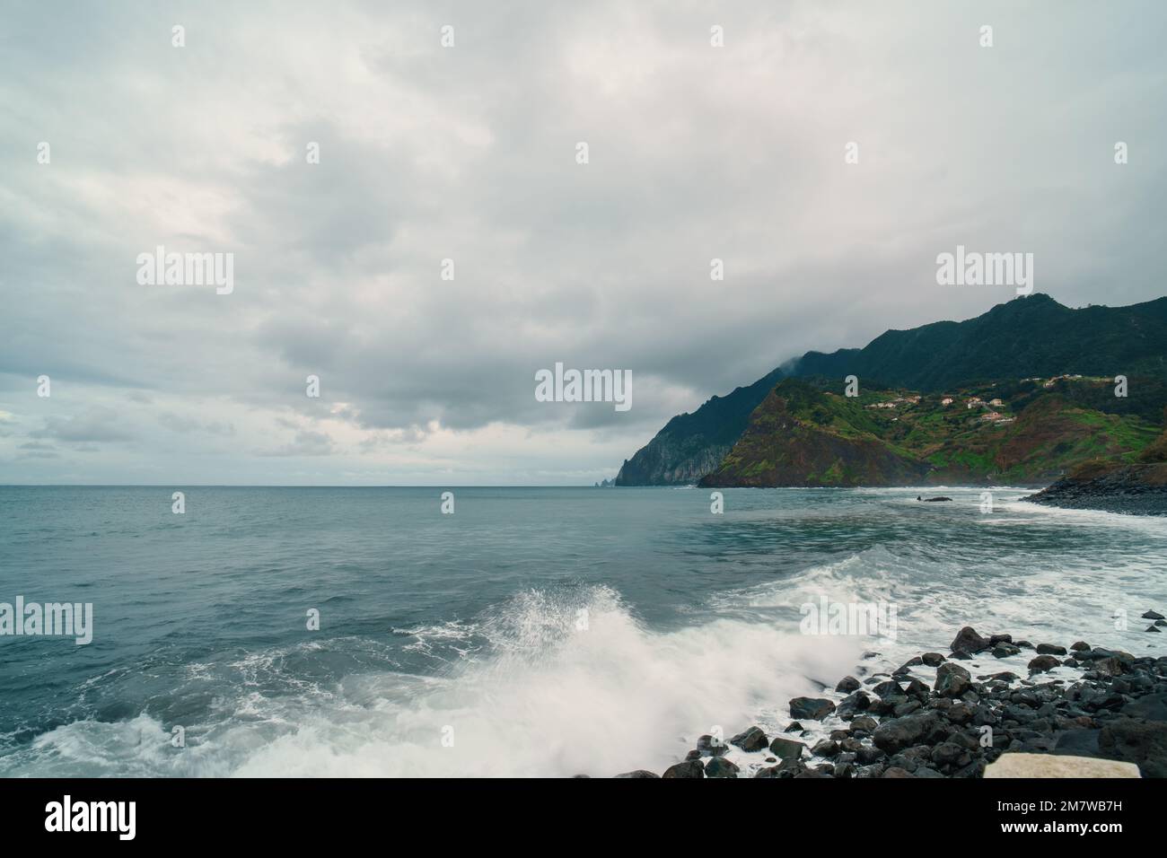The splashing wave sat the rocky coast of Madeira Island bay Stock ...