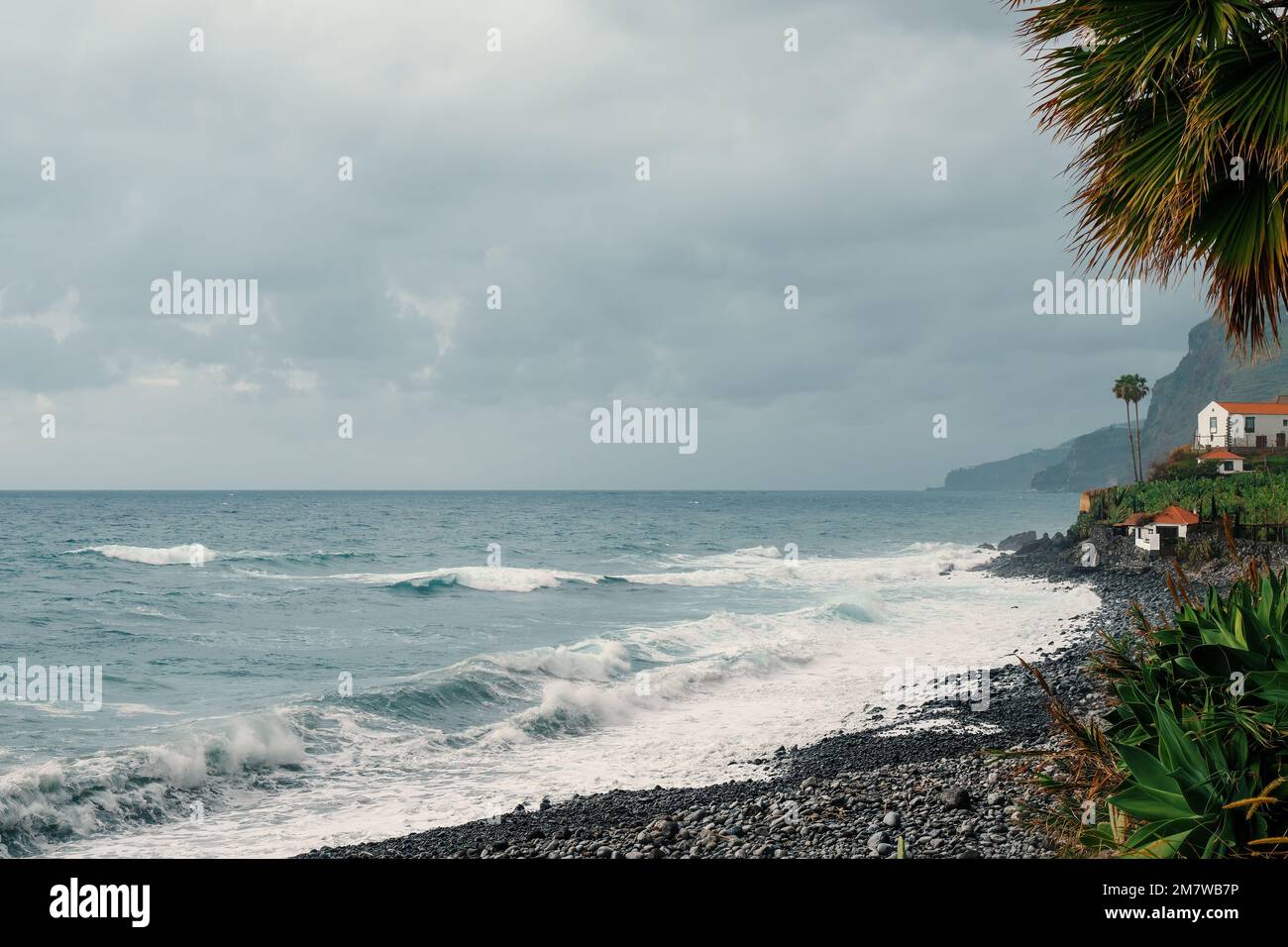 The splashing wave sat the rocky coast of Madeira Island bay Stock ...