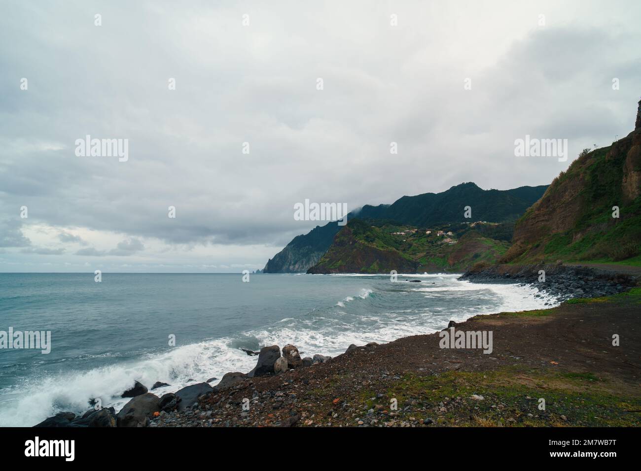 The splashing wave sat the rocky coast of Madeira Island bay Stock ...
