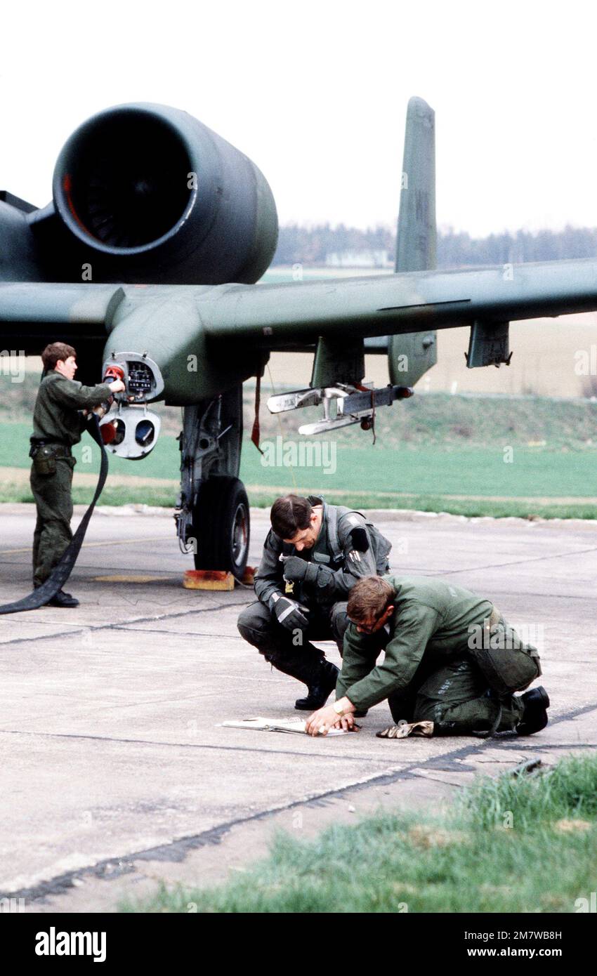 A ground crew performs maintenance on an A-10 Thunderbolt II aircraft ...