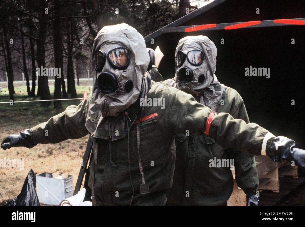 A participant of Exercise UREX '82, wearing chemical warfare gear, is ...