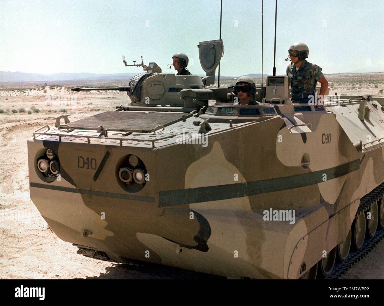 Tracked personnel landing vehicle (LVTP-7) crewmen check the terrain ...