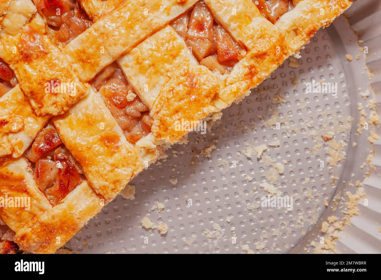 Rustic apple pie, in the round baking pan, with lattice crust, cut, top ...