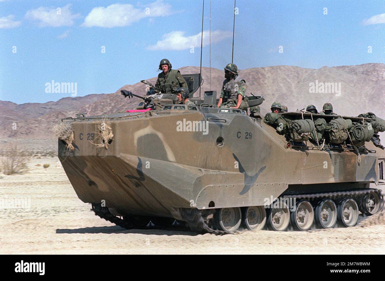Marines ride aboard an LVTP-7 amphibious assault vehicle during ...