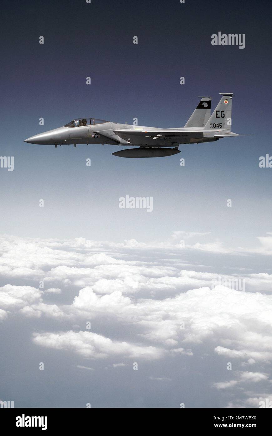 An air-to-air left side view of an F-15 Eagle aircraft from the 33rd ...