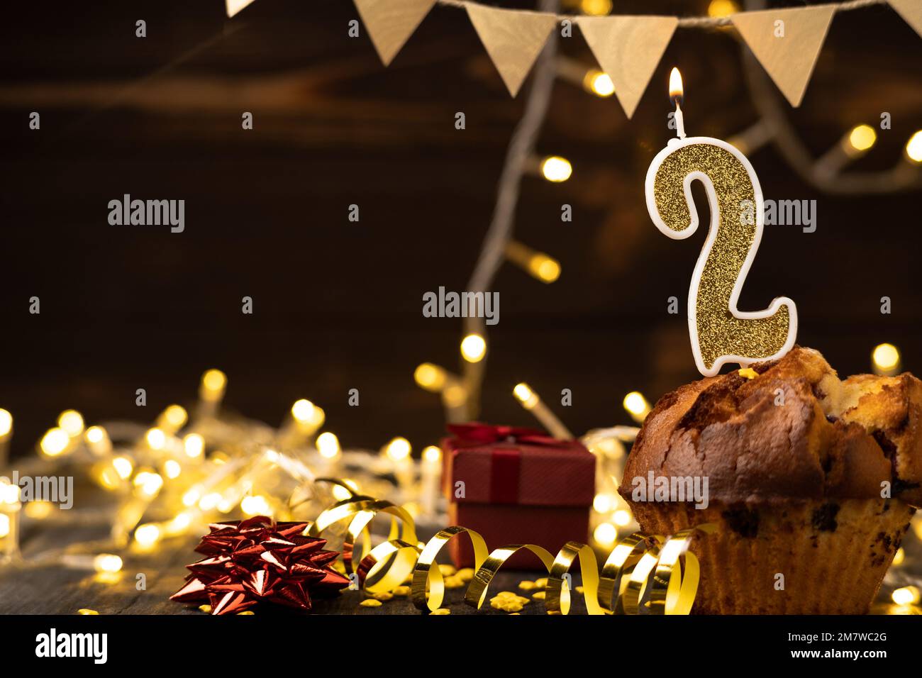 Birthday cake with burning candle number 2 hi-res stock photography and ...