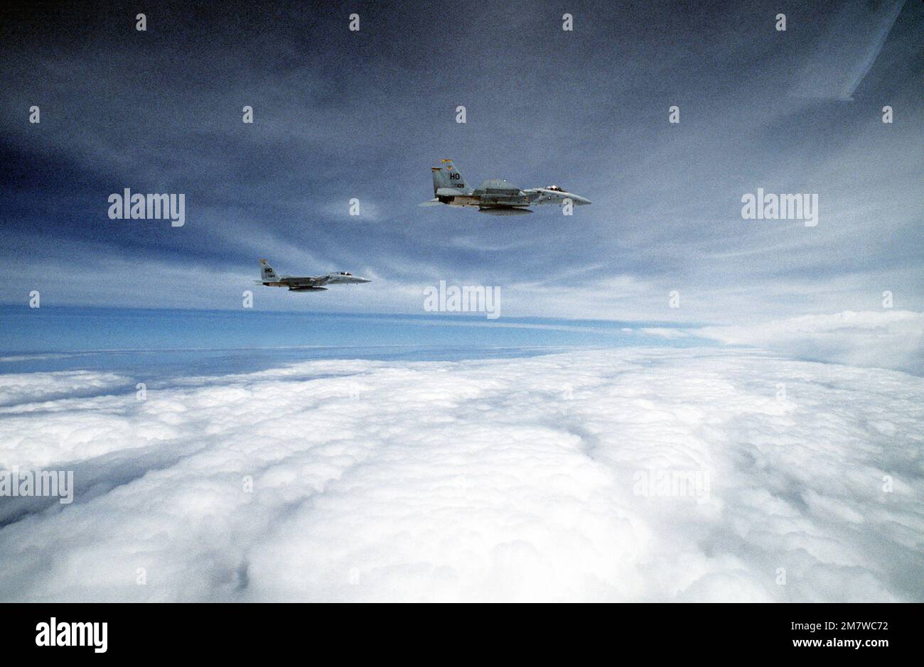 An air-to-air right side view of two F-15 Eagle aircraft from the ...