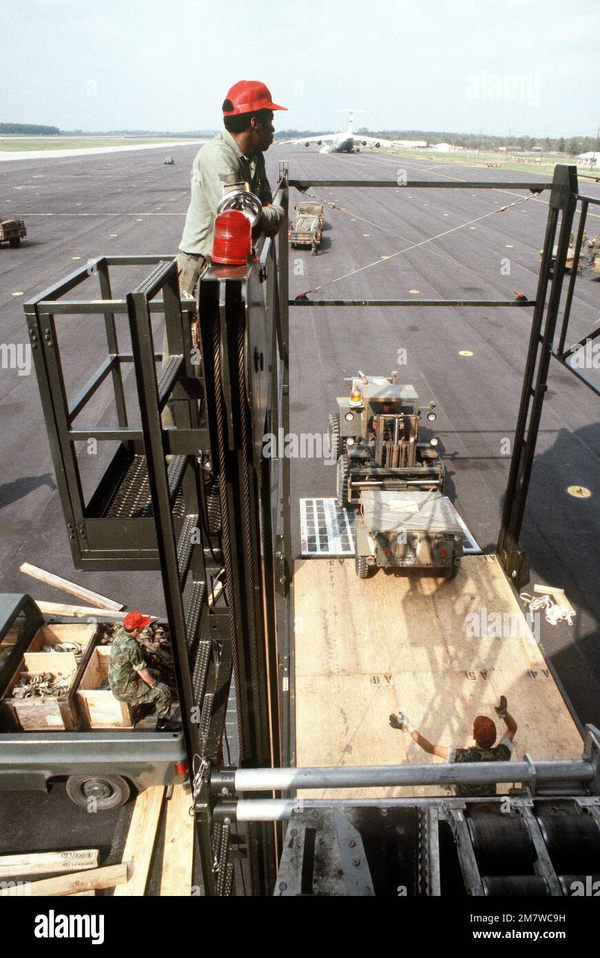 A Cochran elevator loader operator prepares to load a trailer aboard a ...