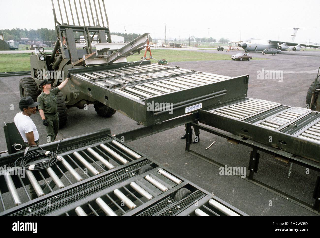 Ground crewmen assemble a Cochran elevator loader to be used for ...