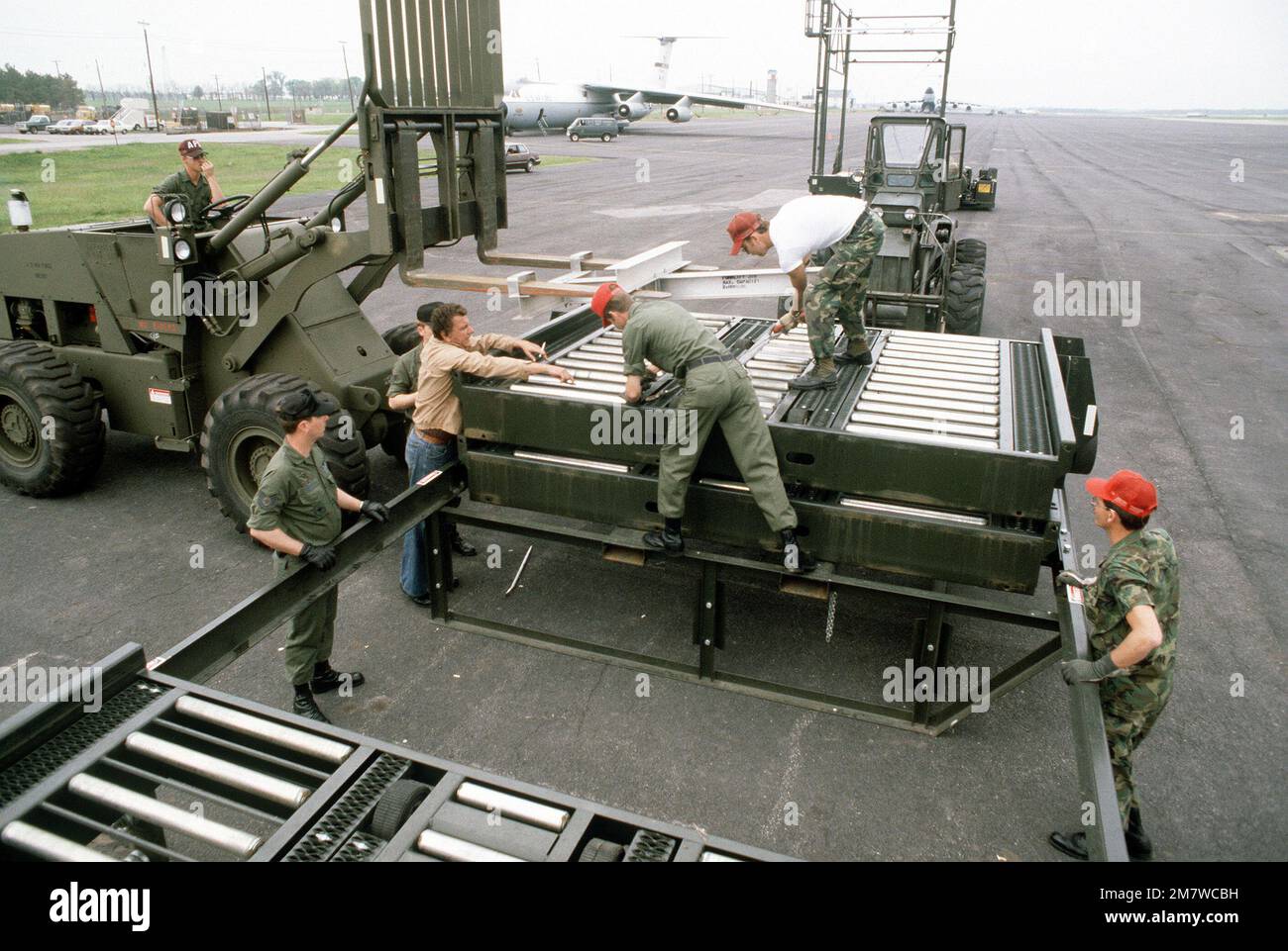 Ground crewmen assemble a Cochran elevator loader to be used for ...