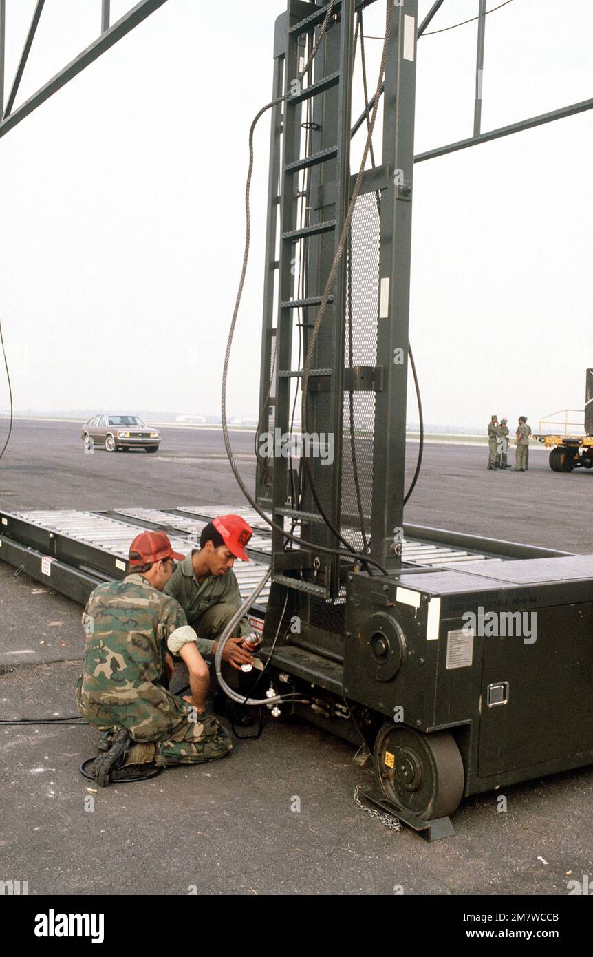 Ground crewmen assemble a Cochran elevator loader to be used for ...