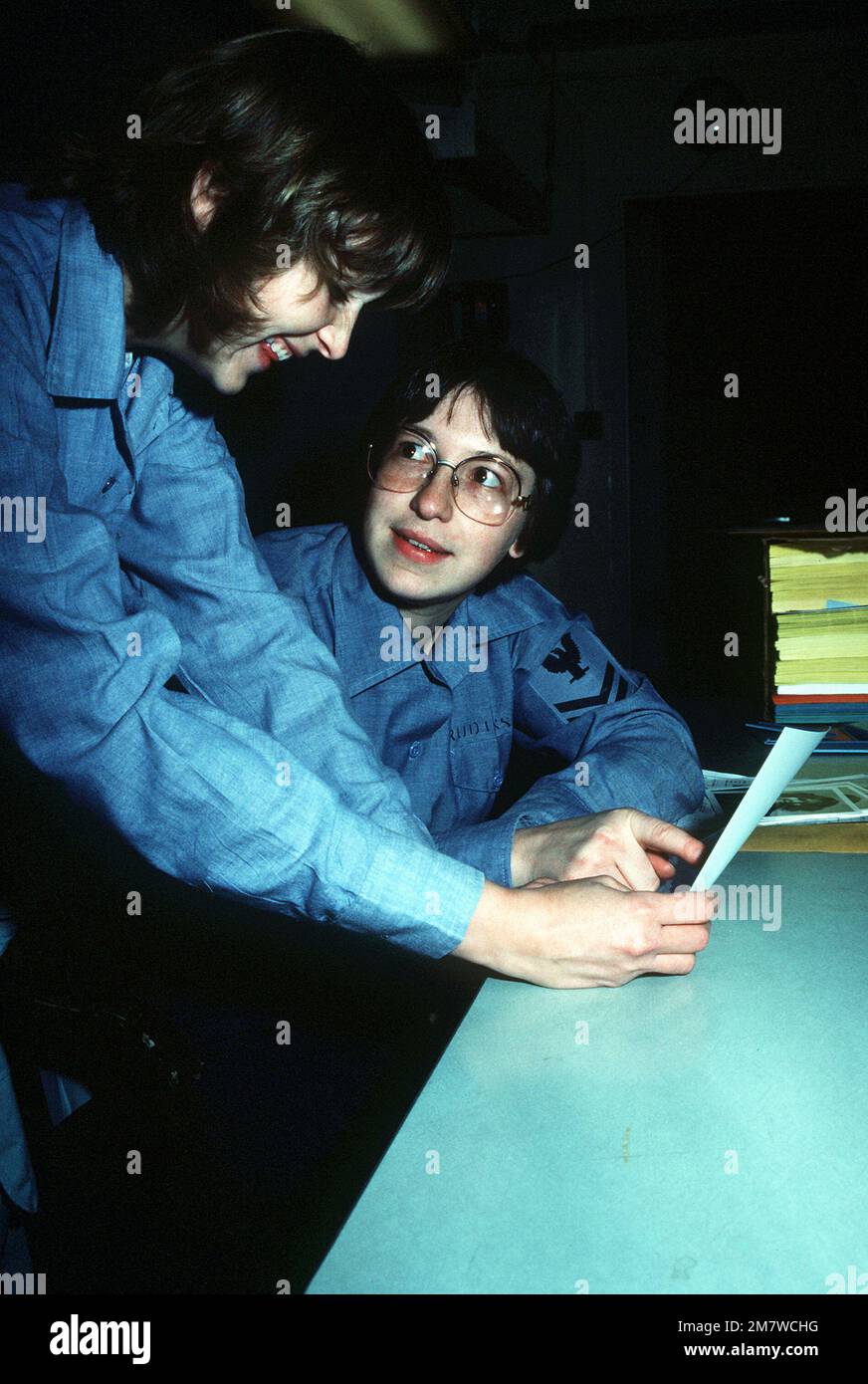 PH2 Melanie Rudinsky, production petty officer, seated, assists PHAN ...