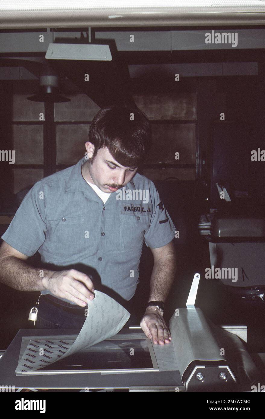 PH3 Curt Fargo mounts prints for an armed forces display at the Pacific ...