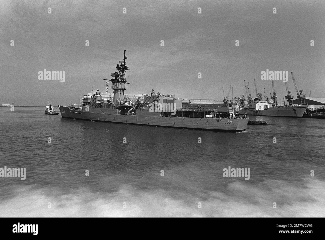 Port quarter view of the frigate USS W. S. SIMS (FF-1059) leaving port ...