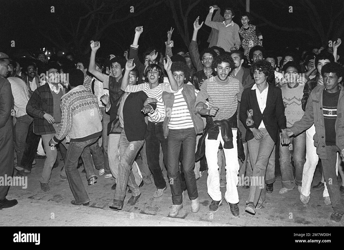 A crowd of people dance as the U.S. Navy Sixth Fleet Band plays for ...