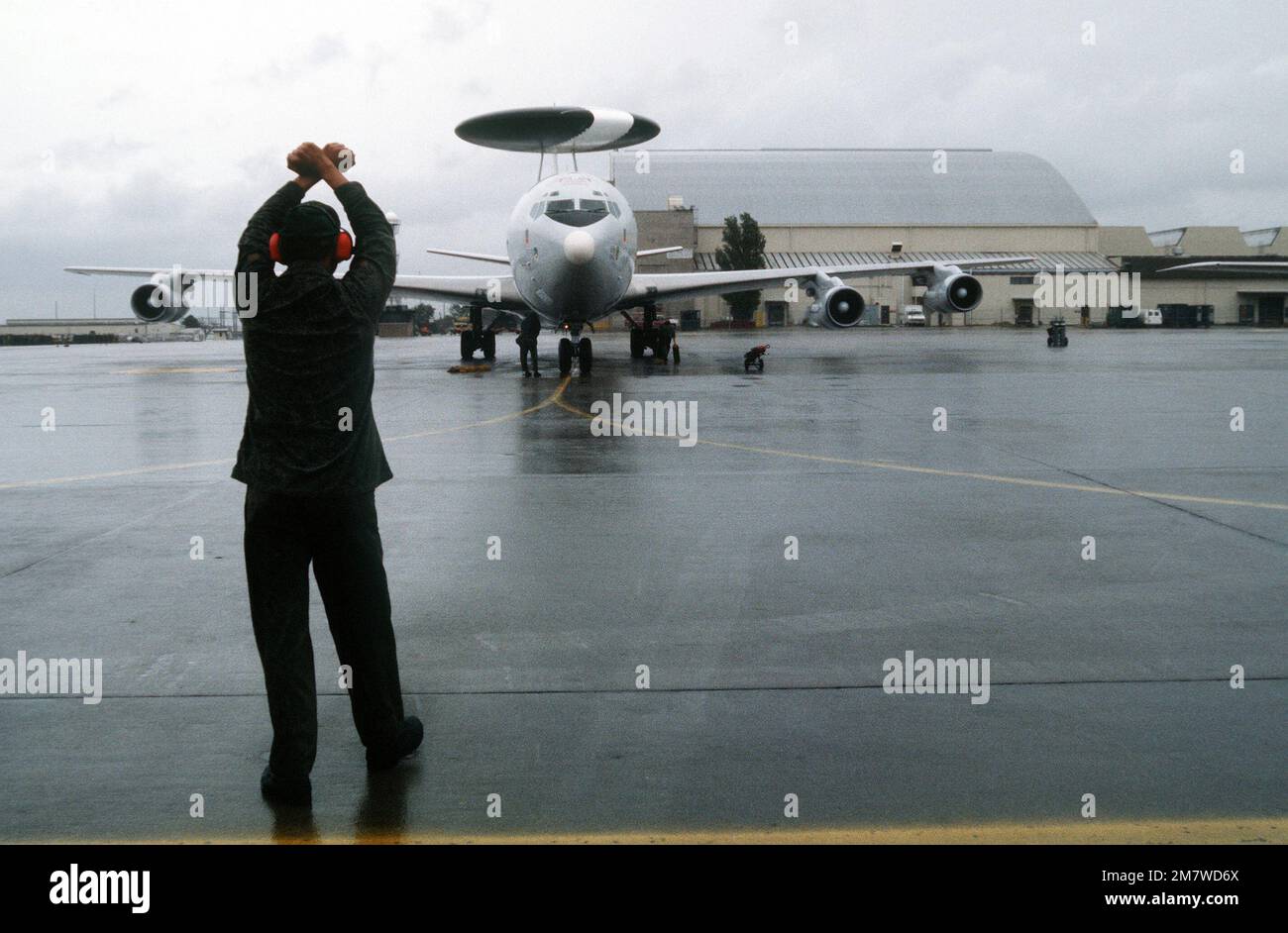 A1C K. Miller marshals an E-3A Sentry aircraft to its chocks, upon ...