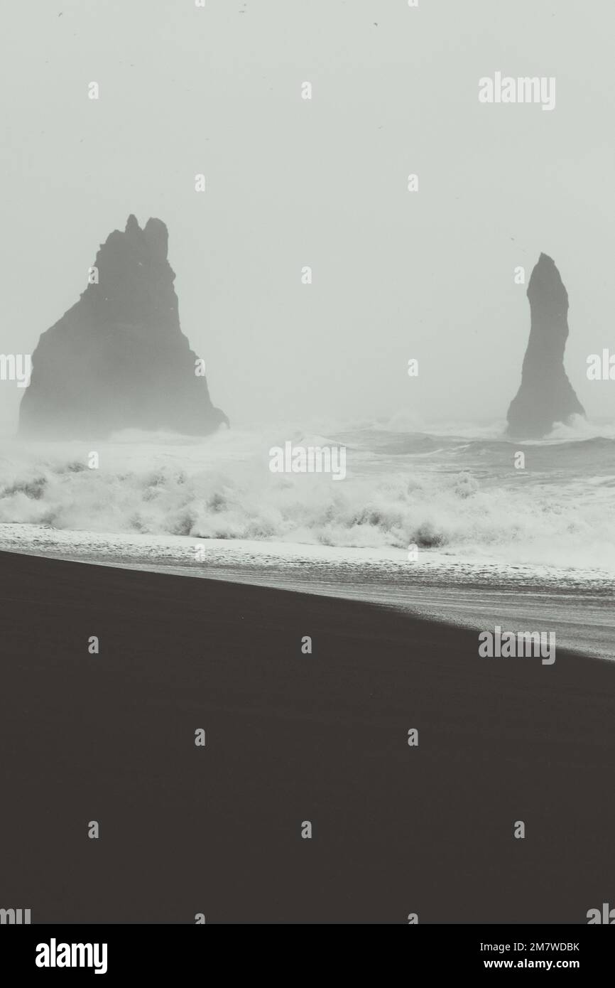 Weathered rocks on beach monochrome landscape photo Stock Photo - Alamy