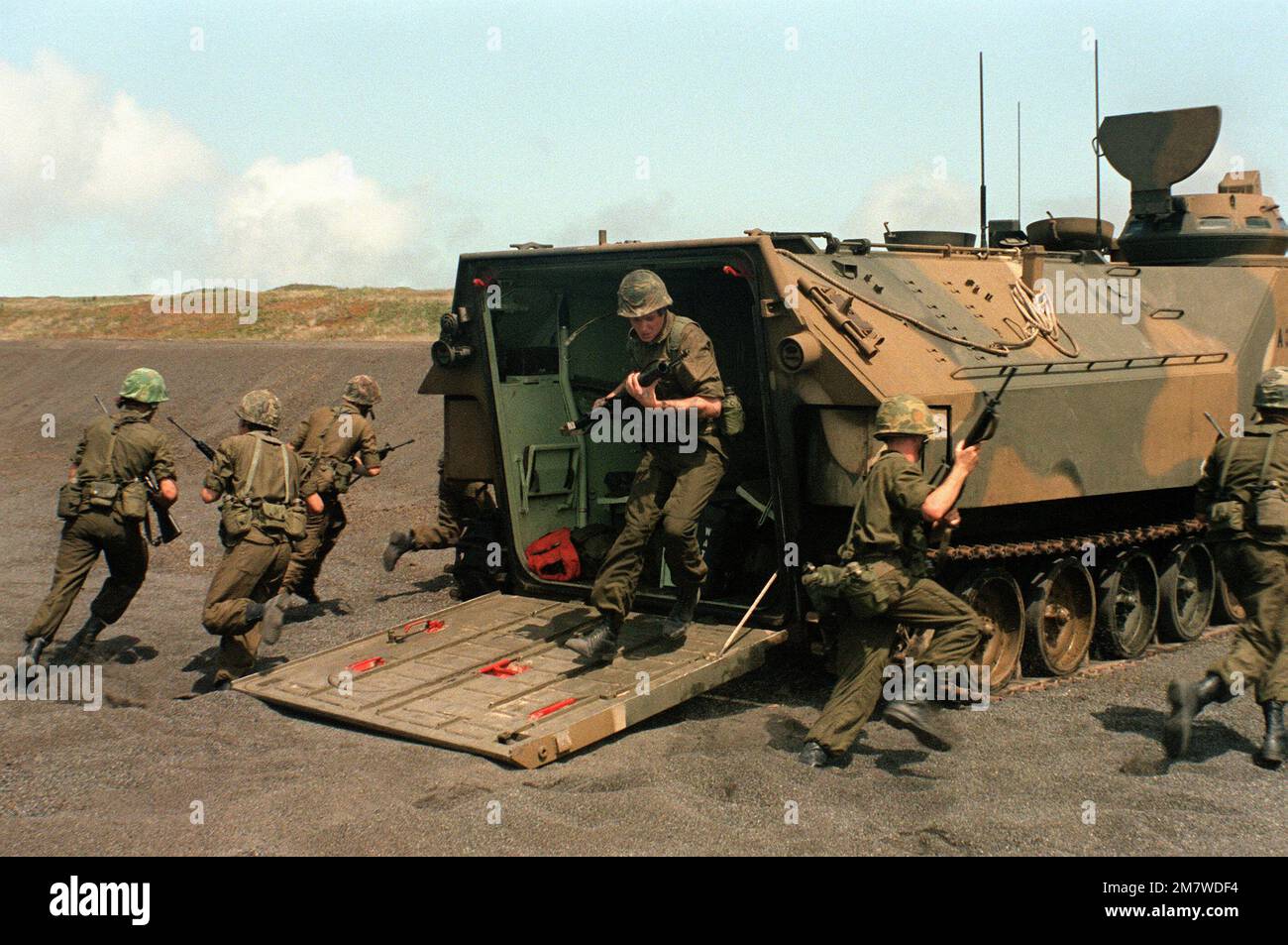 Members of the 31st Marine Amphibious Unit charge out the rear of a ...