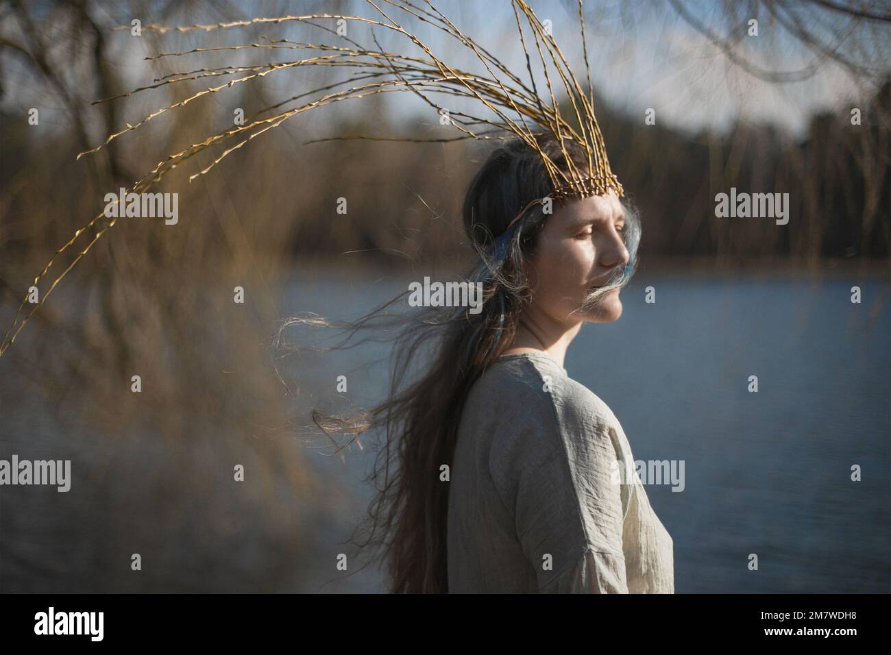 Close up adult lady with willow crown enjoying breeze portrait picture Stock Photo - Alamy