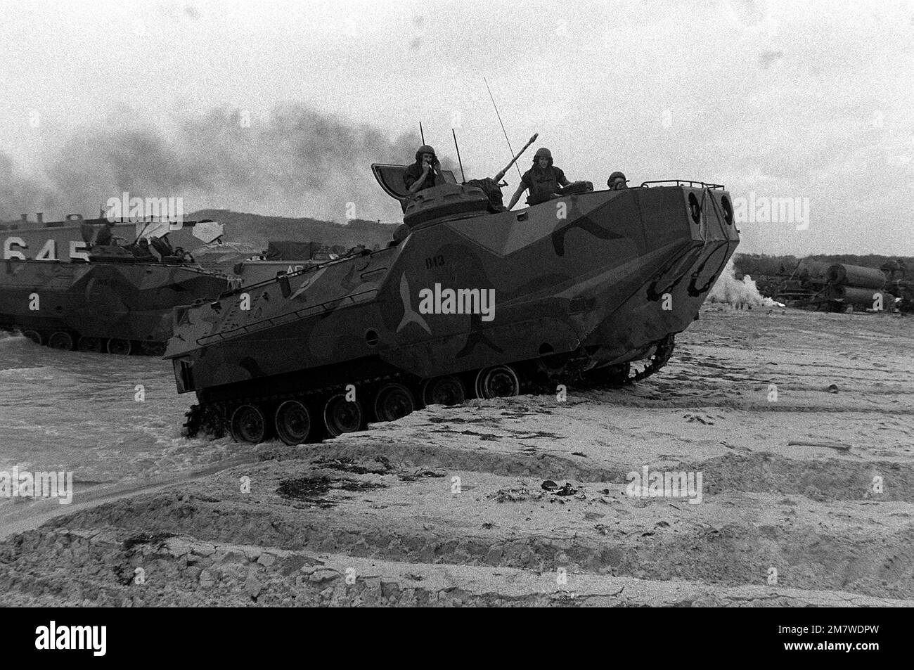 An LVTP-7 tracked landing vehicle comes ashore during a beach assault ...