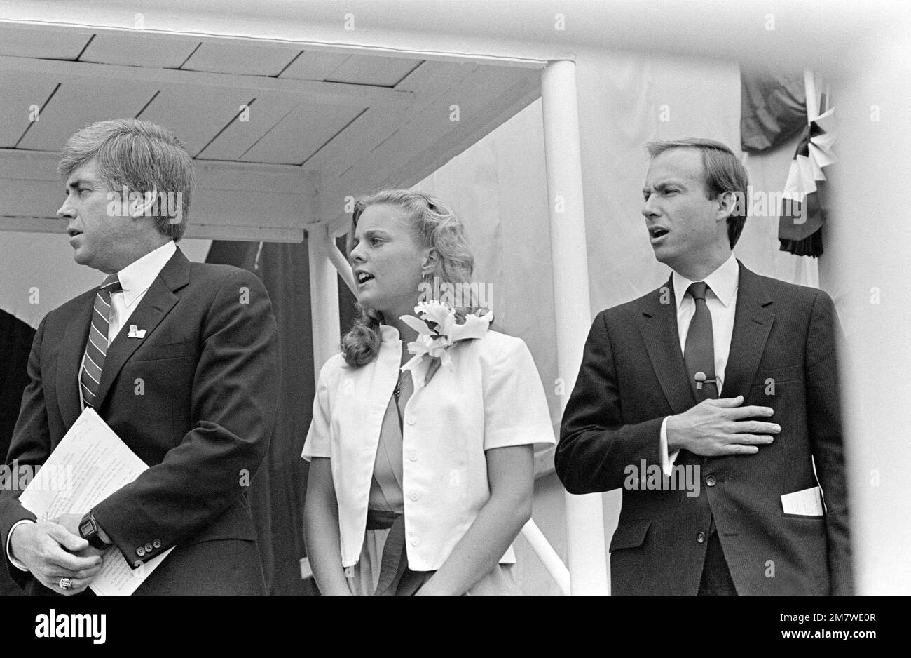 Guests of honor sing as the national anthem is played during the ...