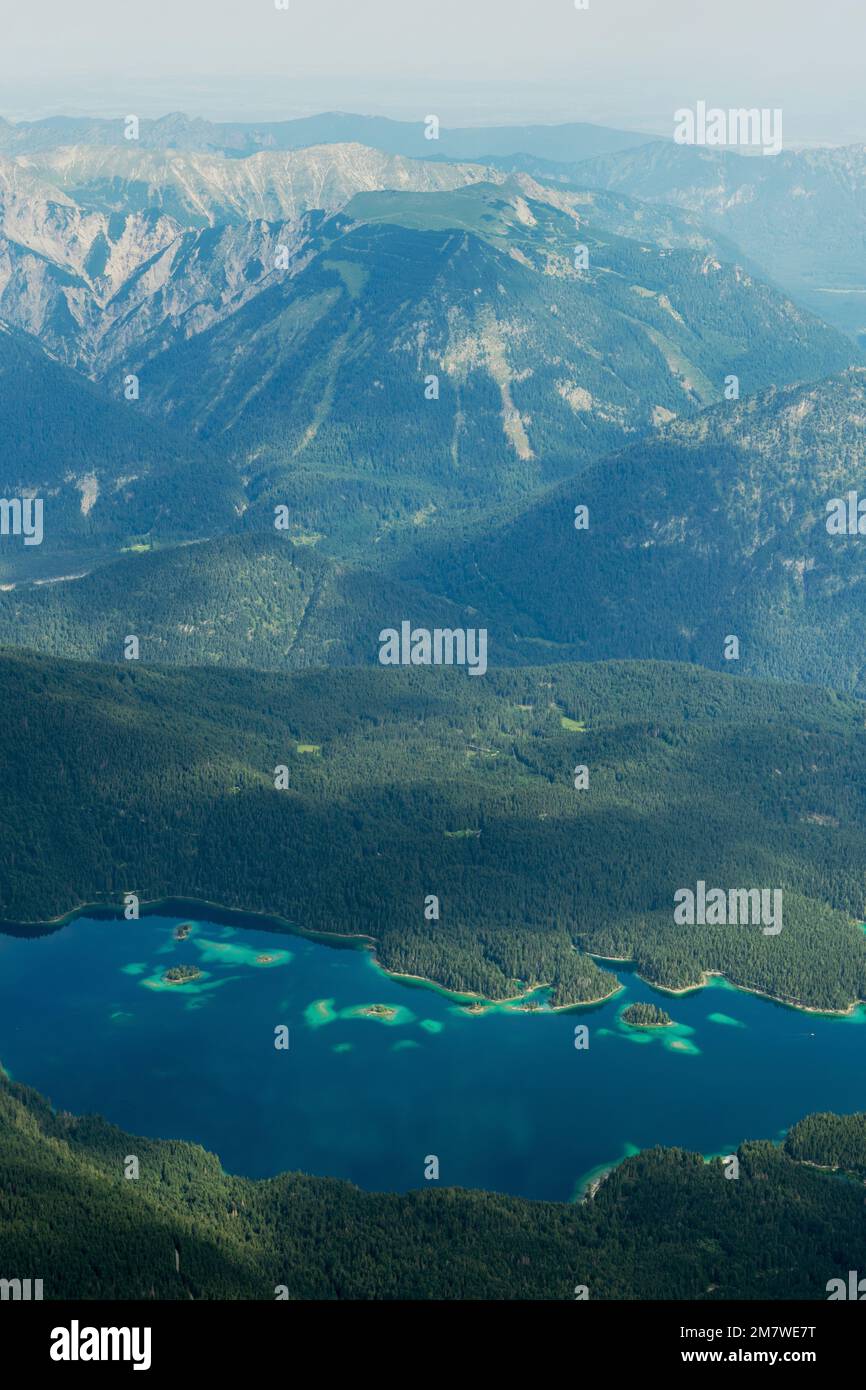 A bird's eye view of a lake in green mountain seen from Zugspitze ...