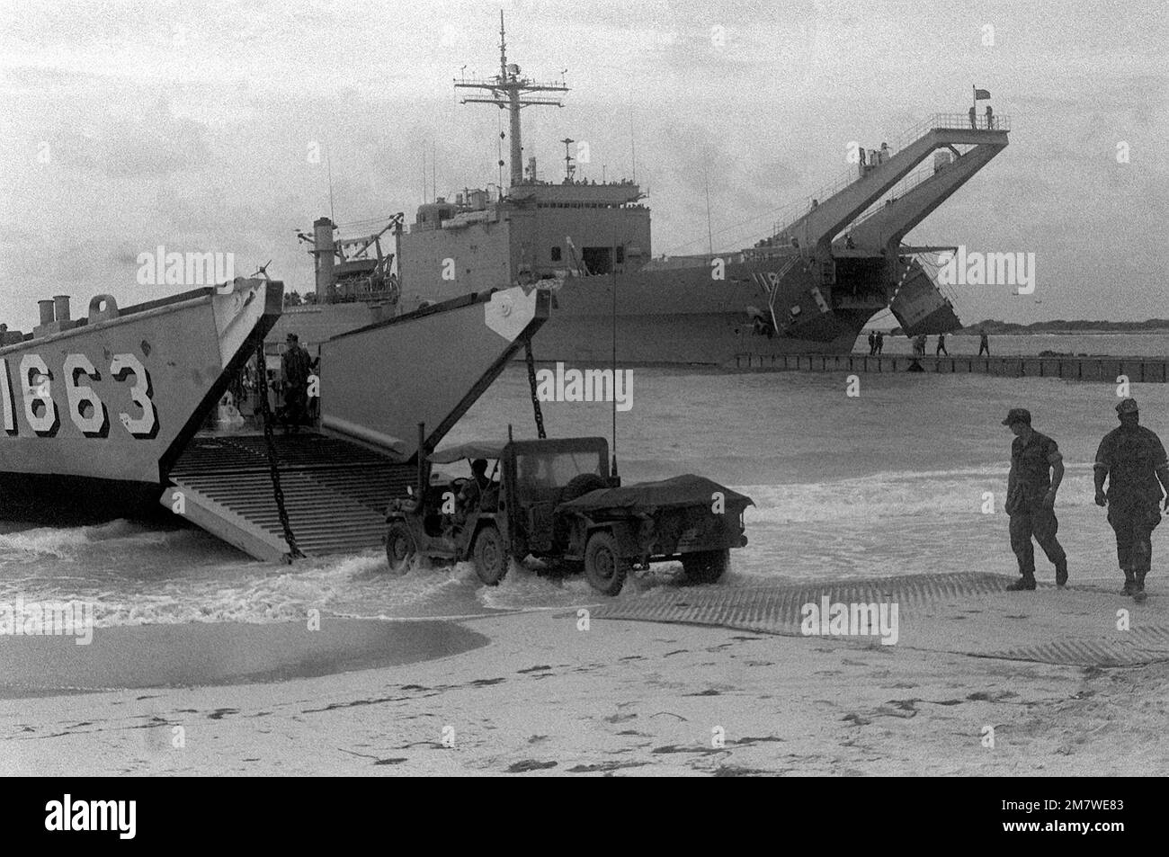Equipment is offloaded from a utility landing craft (LCU-1663) and a ...