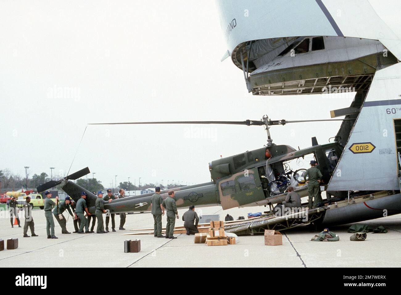 A UH-1N Iroquois helicopter is loaded aboard a C-5 Galaxy aircraft ...