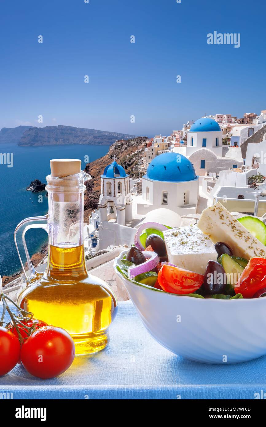 Greek food against famous churches in Oia village on Santorini island ...