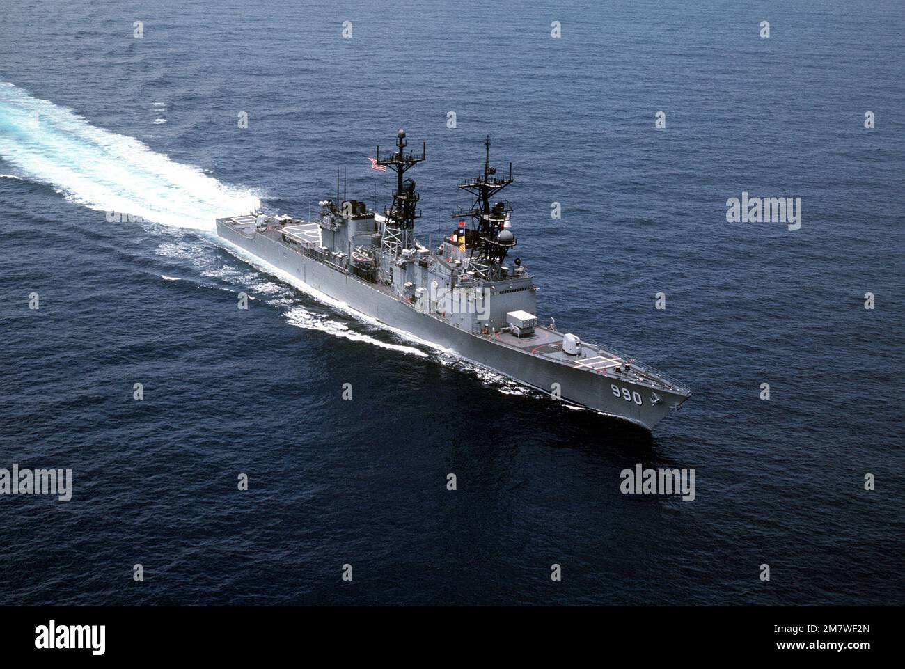 A high-angle starboard bow view of the Spruance class destroyer USS ...