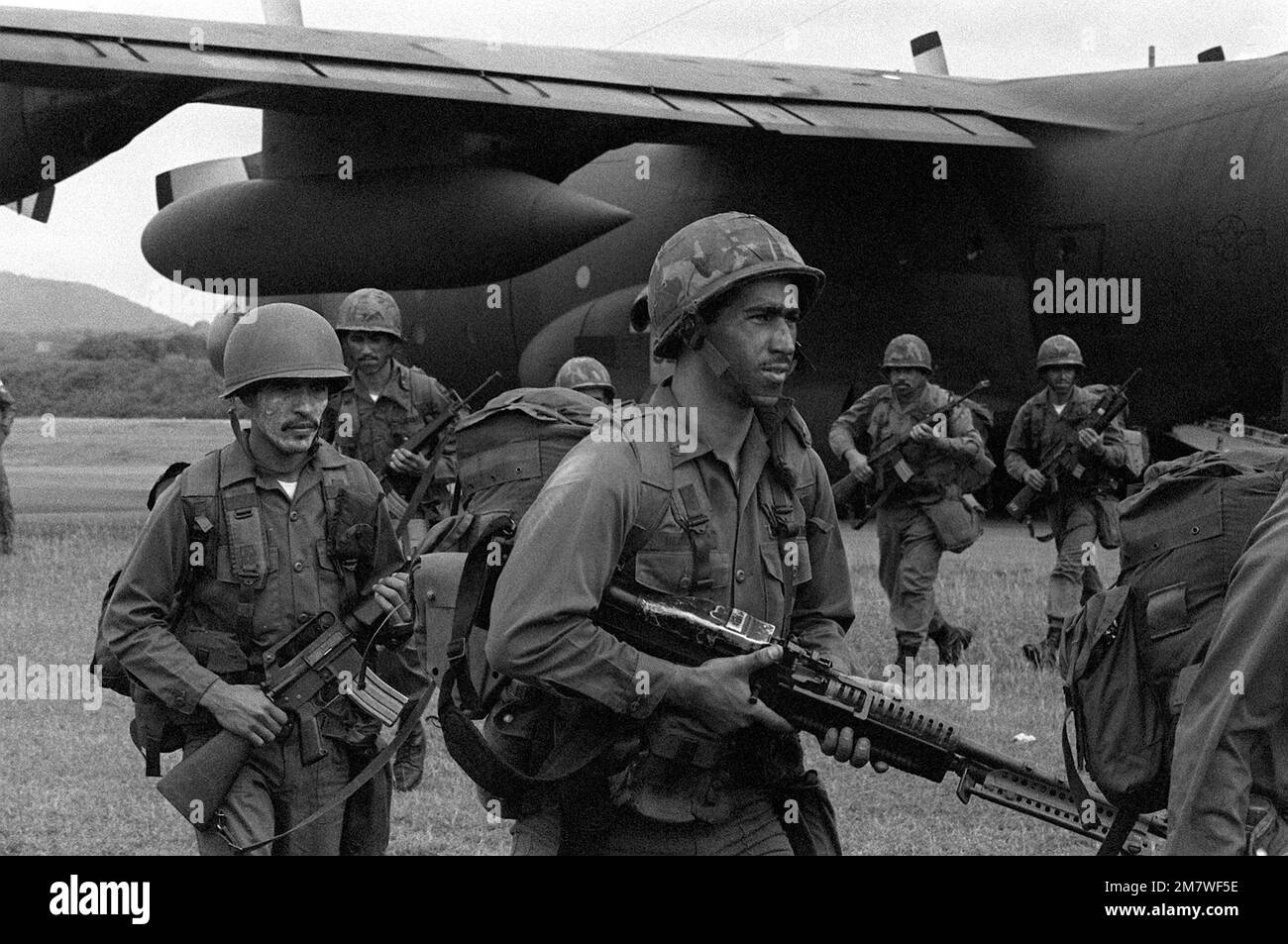 Puerto Rican National Guardsmen disembark from a C-130 Hercules ...