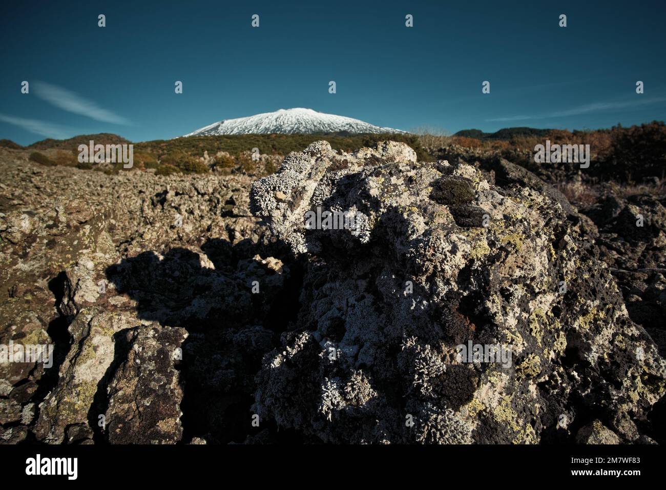 volcano rocks old lava field and blurred winter Mount Etna in Sicily ...