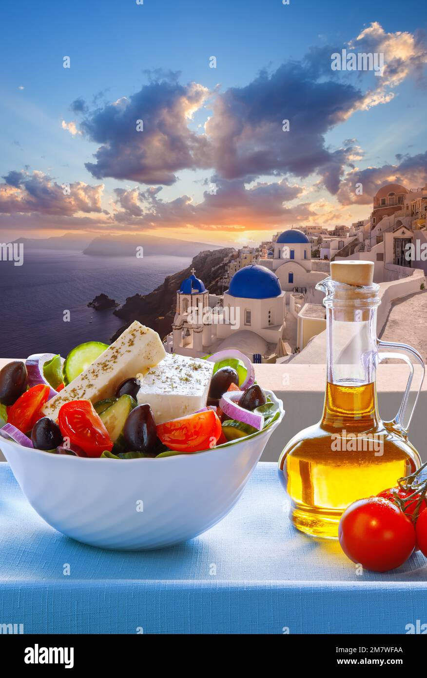 Greek food against famous churches in Oia village on Santorini island ...