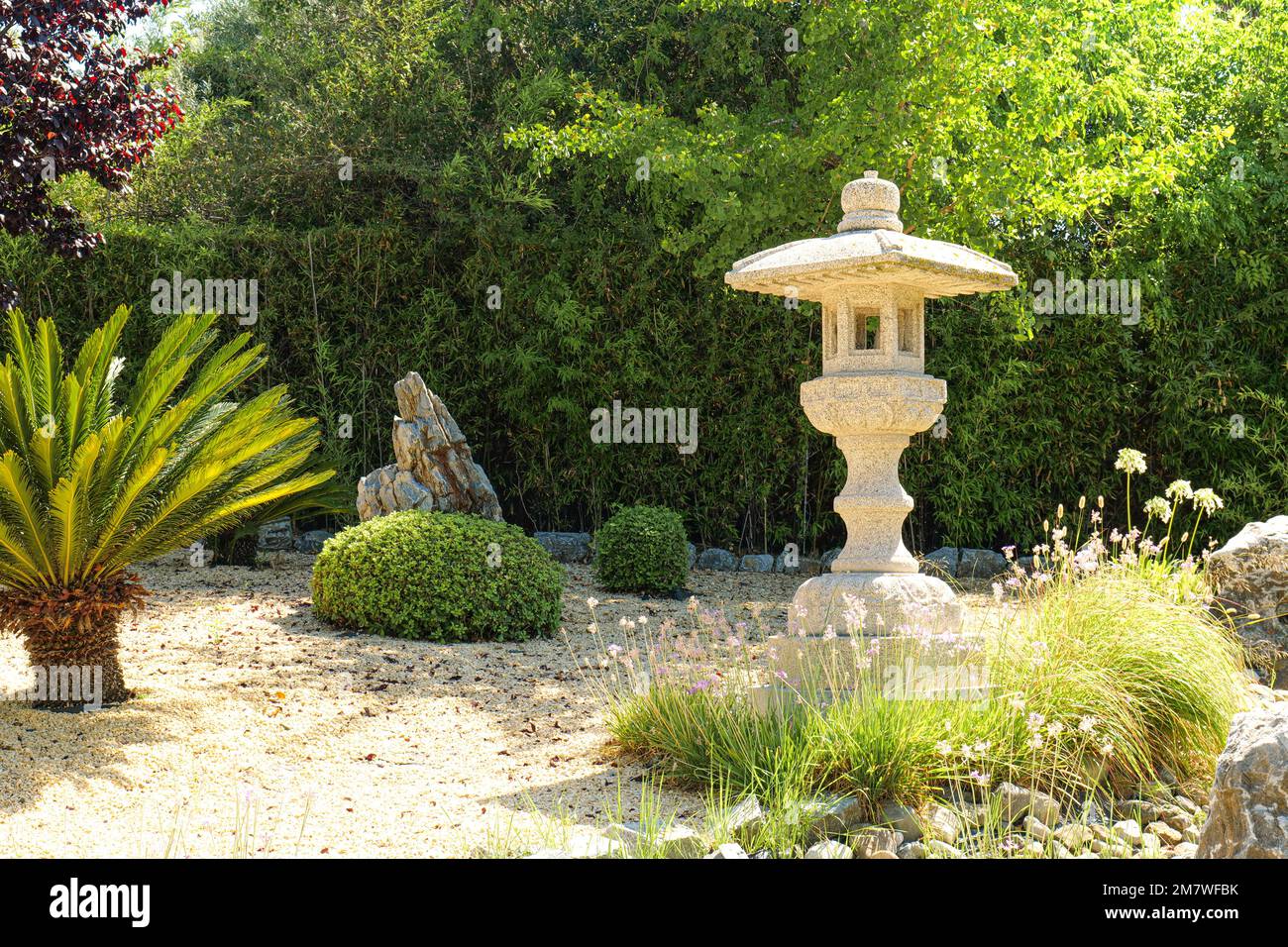 Amazing view on Japanese garden with a stone lantern Stock Photo - Alamy