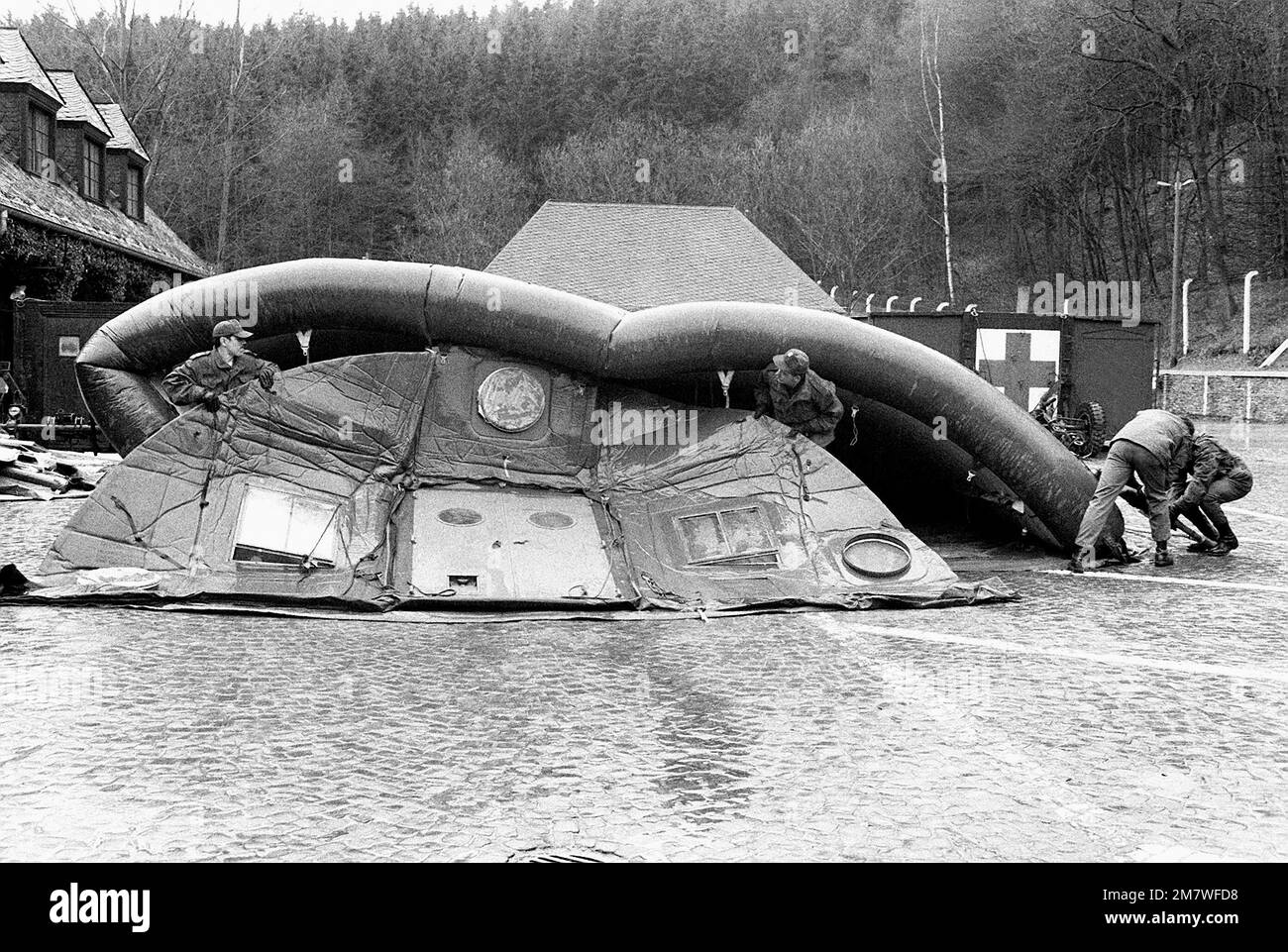 A view of the emergency ward tent being assembled by personnel from the ...