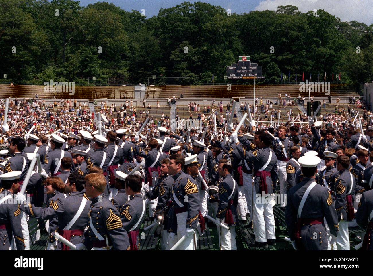Cadets wave their diplomas at their parents at the conclusion of ...