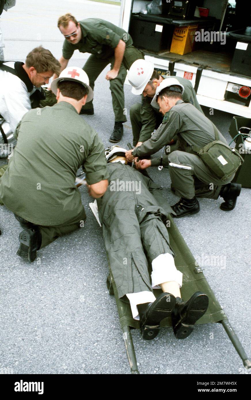 An "injured" space shuttle commander is treated by an emergency medical ...