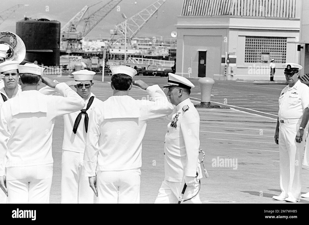 ADM Sylvester R. Foley Jr. walks through two rows of side boys at the ...