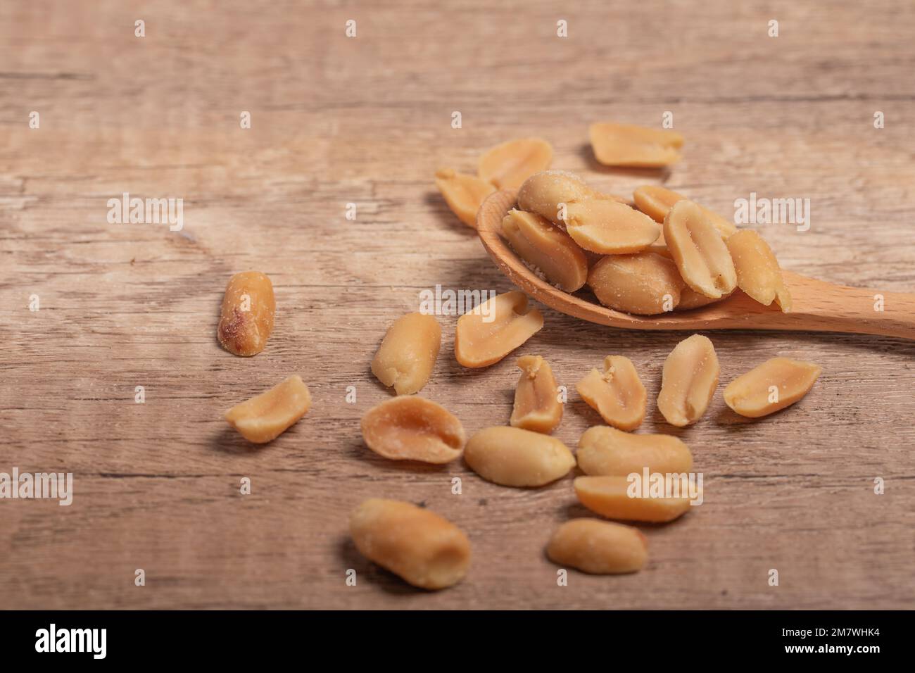 salted roasted peanuts on wooden background Stock Photo - Alamy