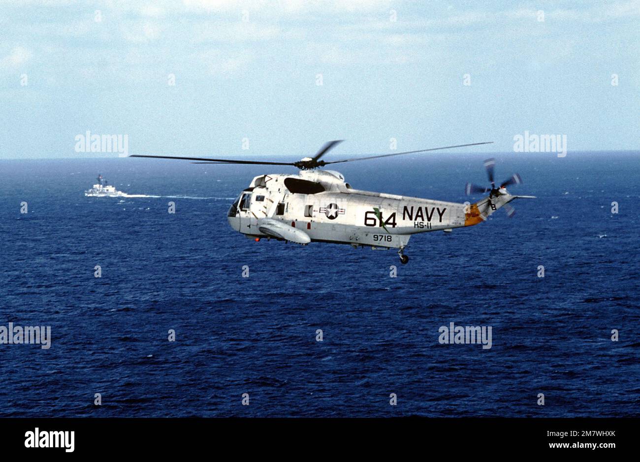 An air-to-air left side view of an SH-3 Sea King helicopter from ...
