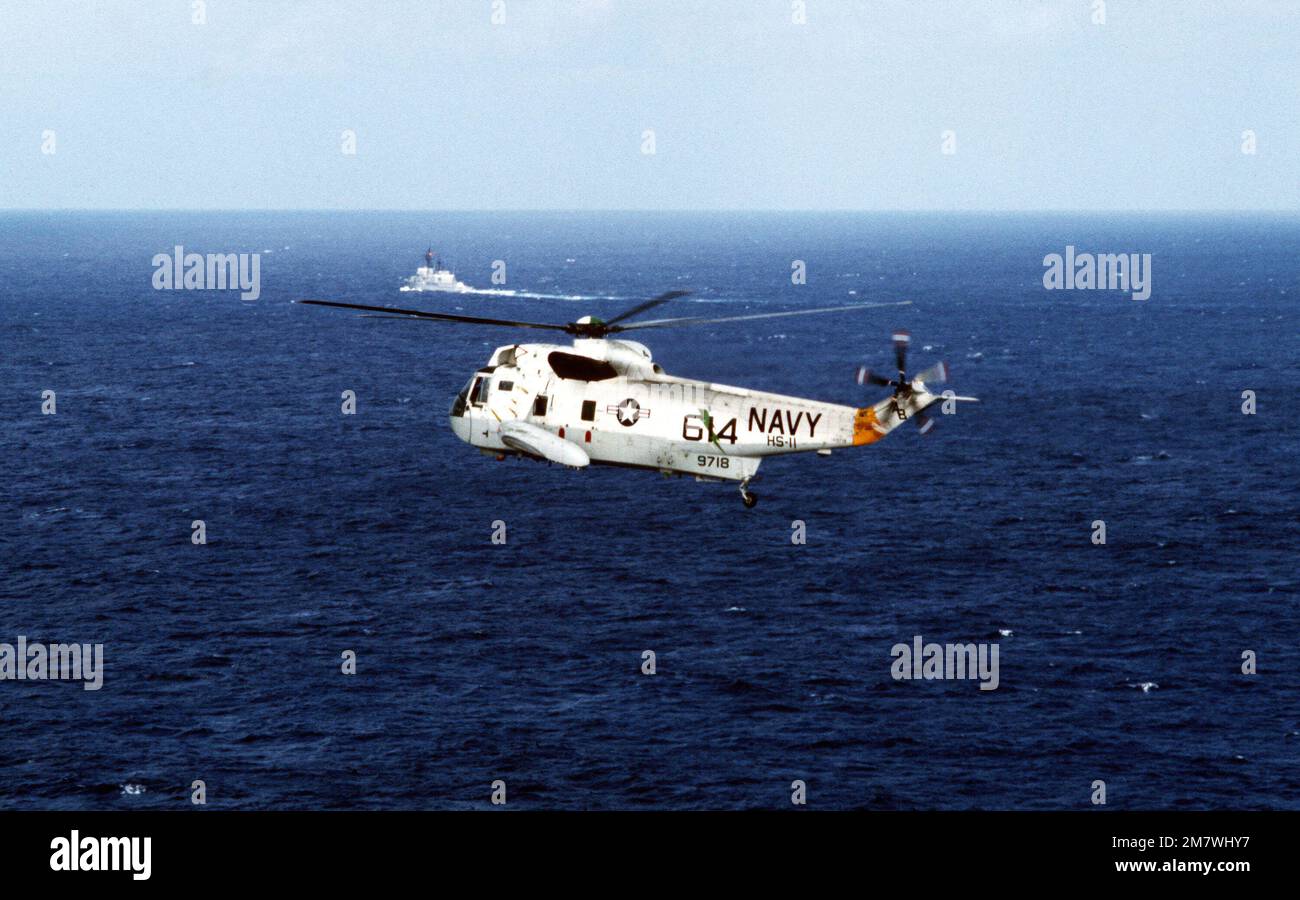 An air-to-air left side view of an SH-3 Sea King helicopter from ...