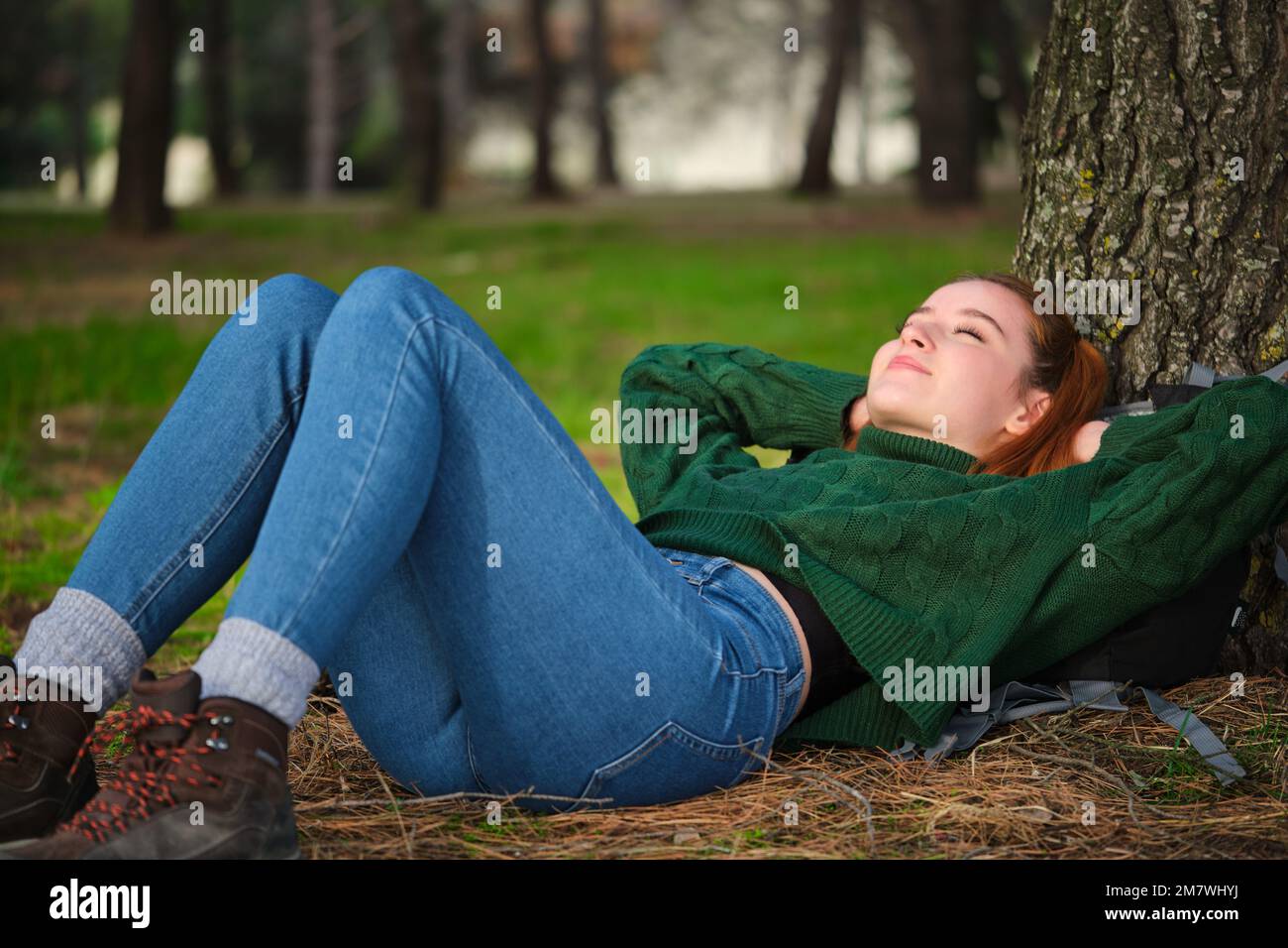 Young woman resting under tree hi-res stock photography and images - Alamy